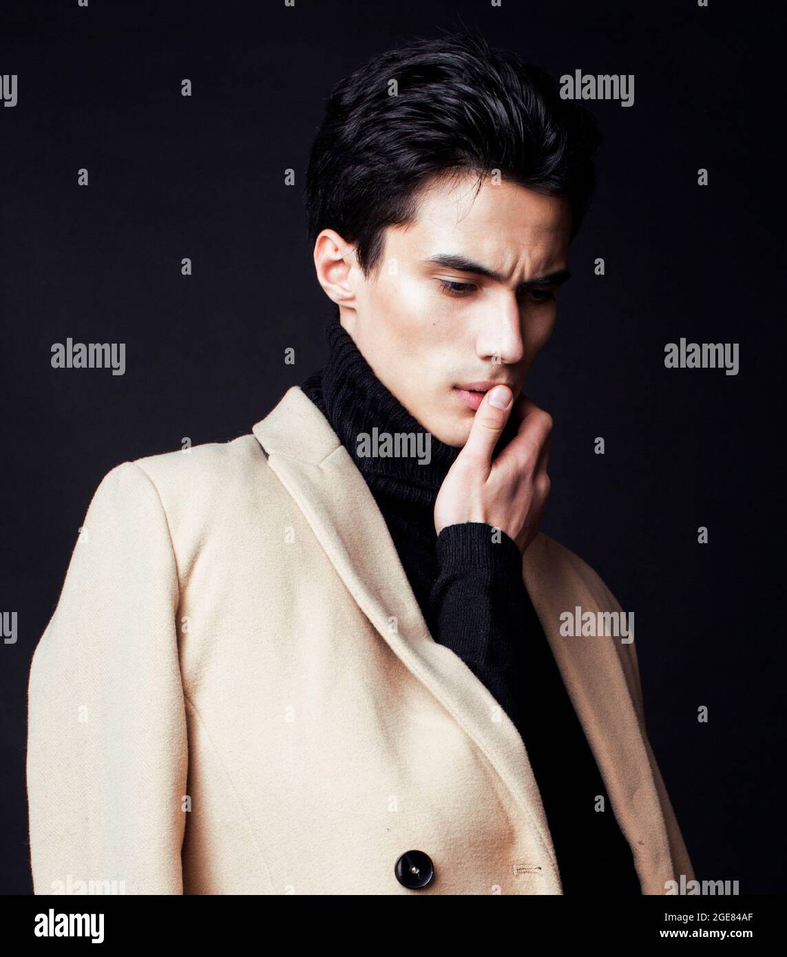 handsome asian fashion looking man posing in studio on black background ...