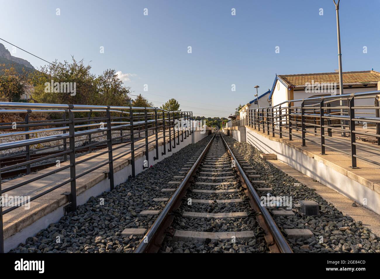 Railway in a station on a sunny day Stock Photo - Alamy