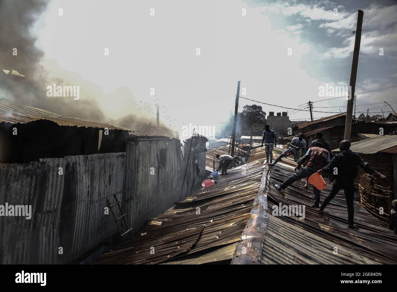 Nairobi, Kenya. 17th Aug, 2021. Locals seen on the rooftop trying to ...