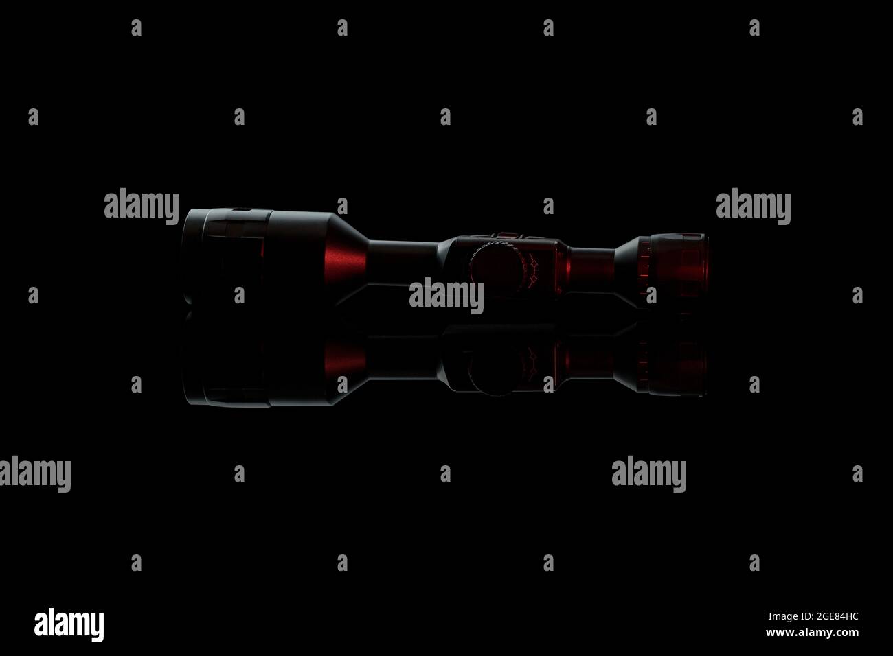 Modern telescopic sight on a smooth mirrored surface. The sight is ...