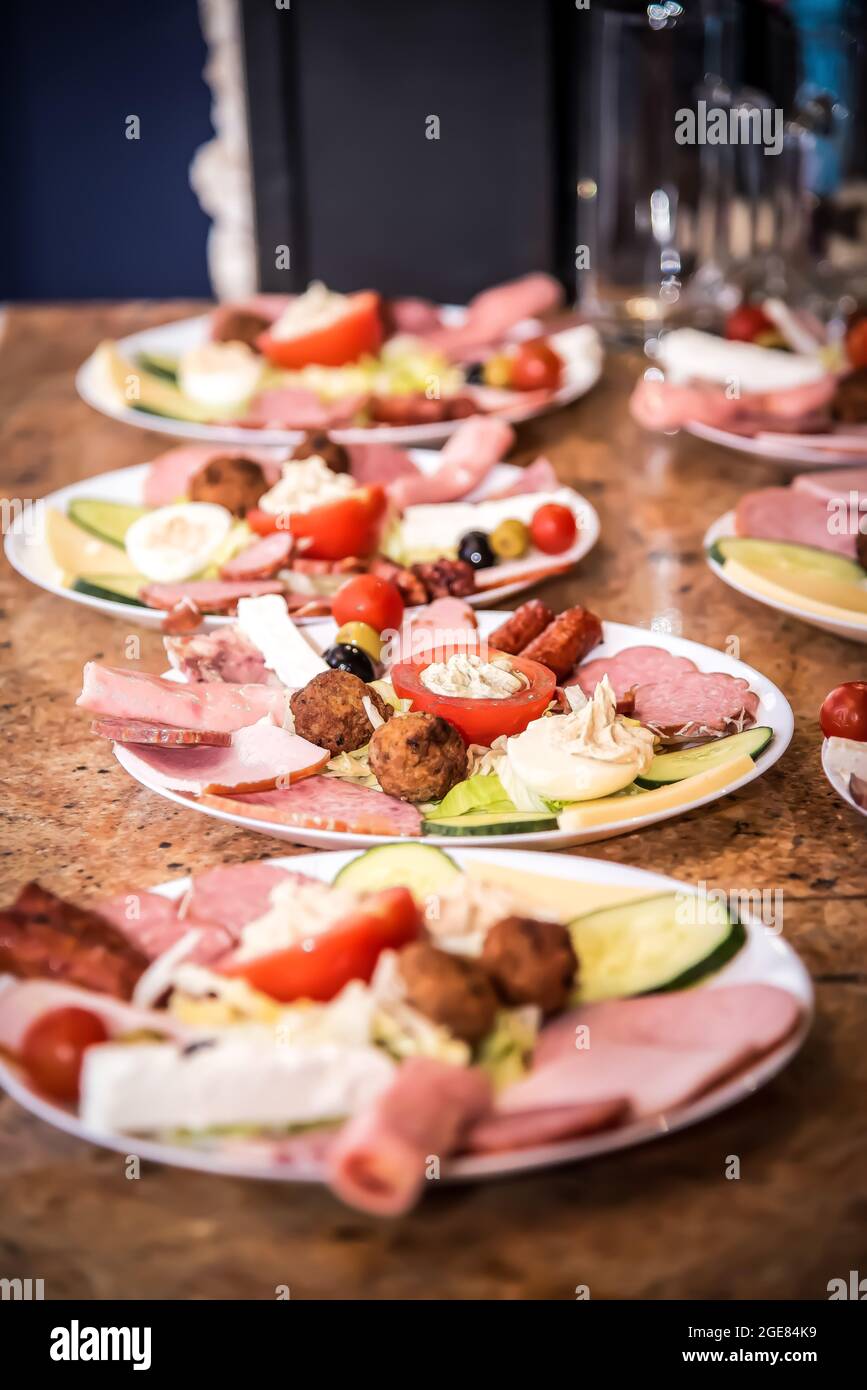 typical plate of Romanian appetizers on the bar counter, plates that ...