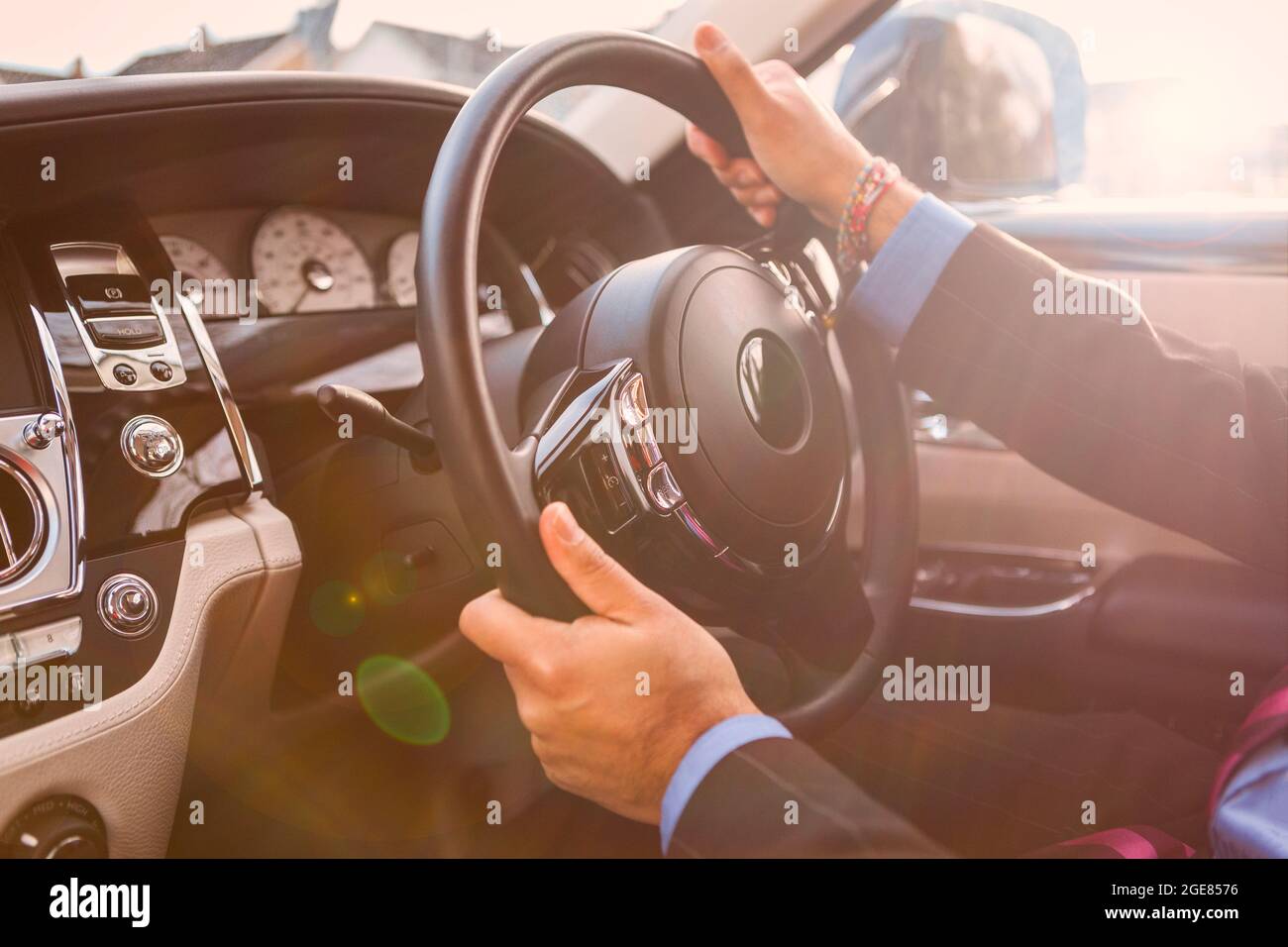 Man dressed in a suit driving a luxury car Stock Photo - Alamy