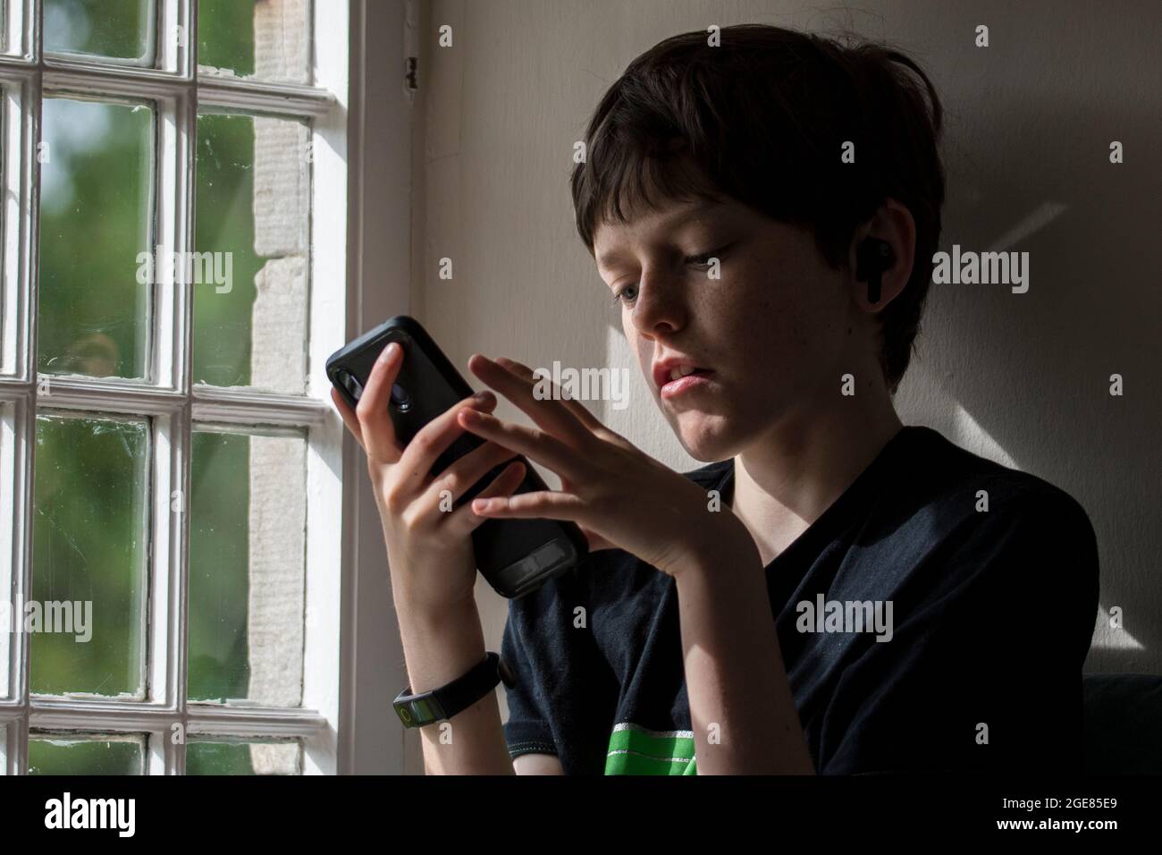 Boy using mobile phone Stock Photo - Alamy