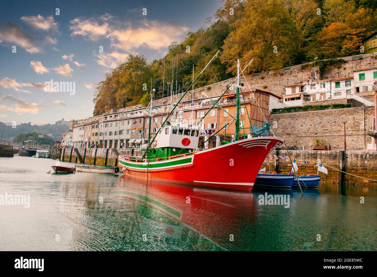 Red boat that stands out from the rest for its bright red color, in the ...