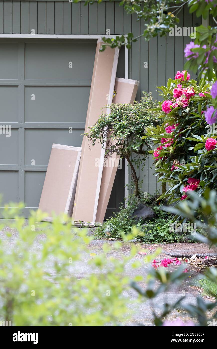 home delivery boxes made of cardboard sitting outside a garage Stock ...