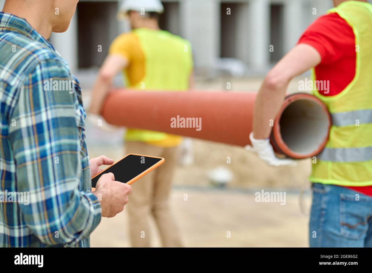 Experienced foreman supervising the work of his colleagues Stock Photo ...