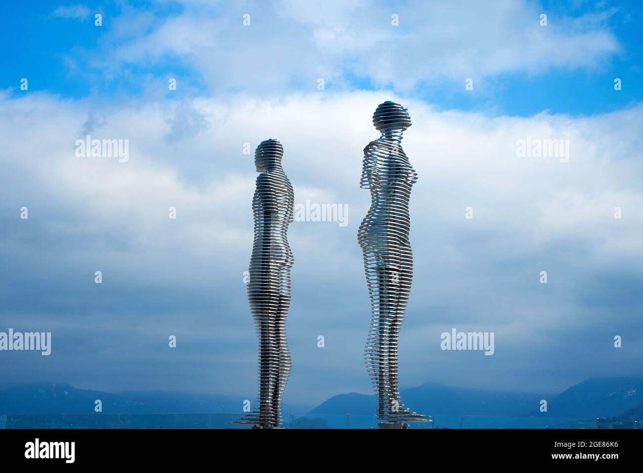 Art object moving figures of a couple of people on the embankment of ...