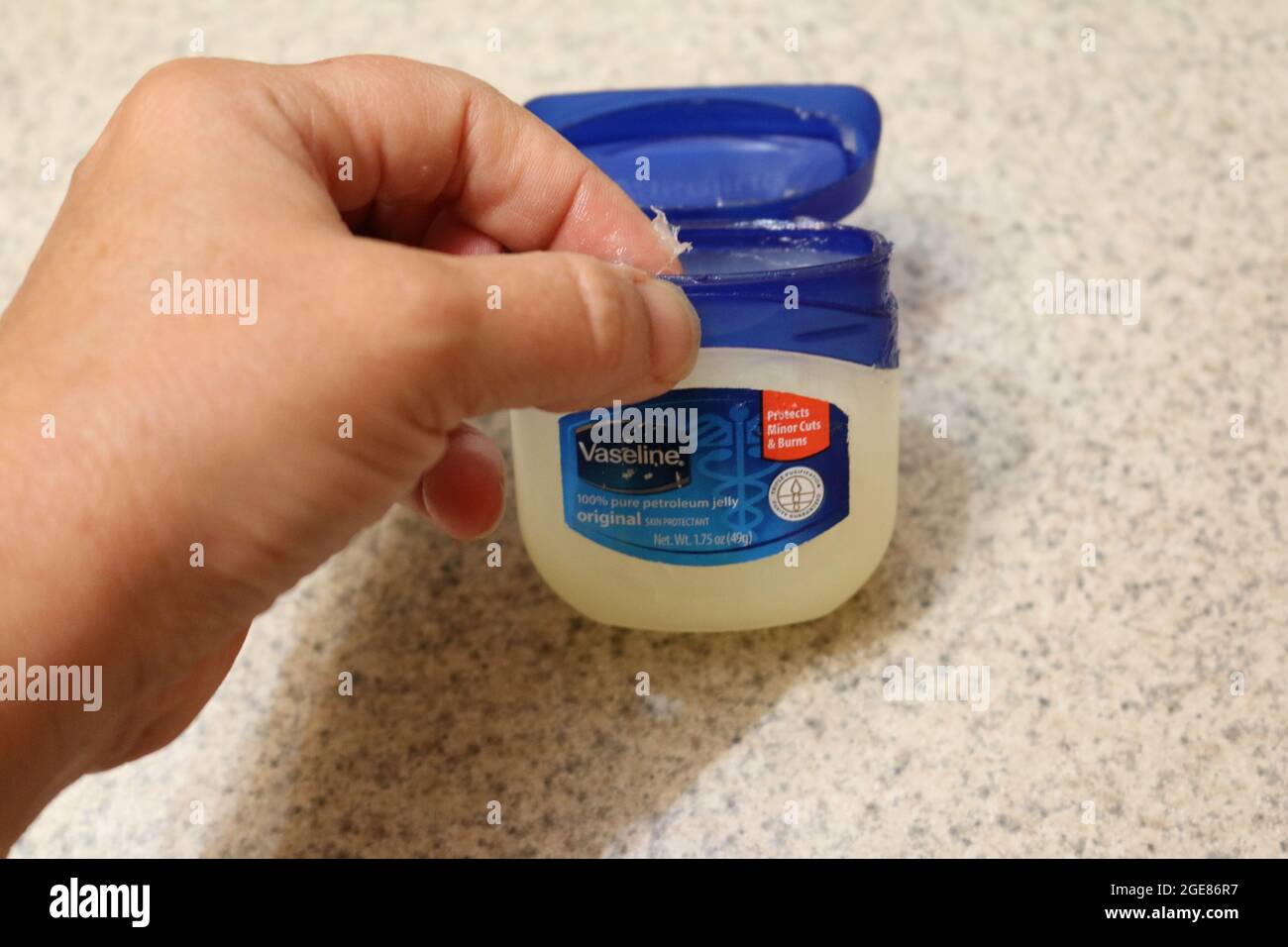 Finger dipping in a Vaseline tub Stock Photo - Alamy