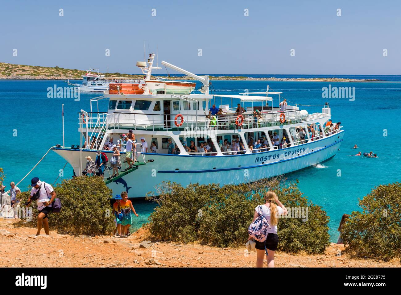 ELOUNDA, CRETE - 16 JULY 2021: Groups of tourists swim around and ...