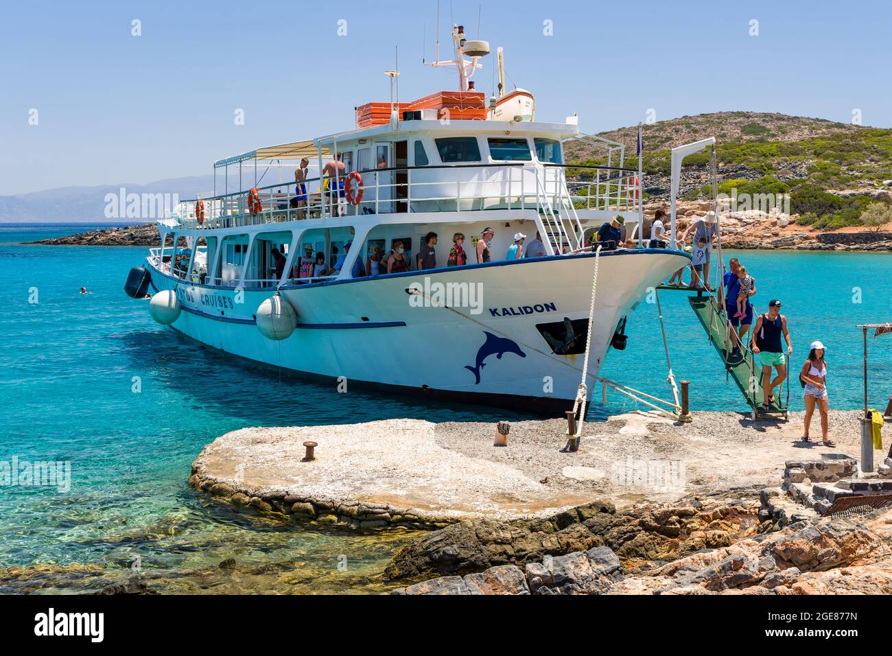ELOUNDA, CRETE - 16 JULY 2021: Groups of tourists swim around and ...