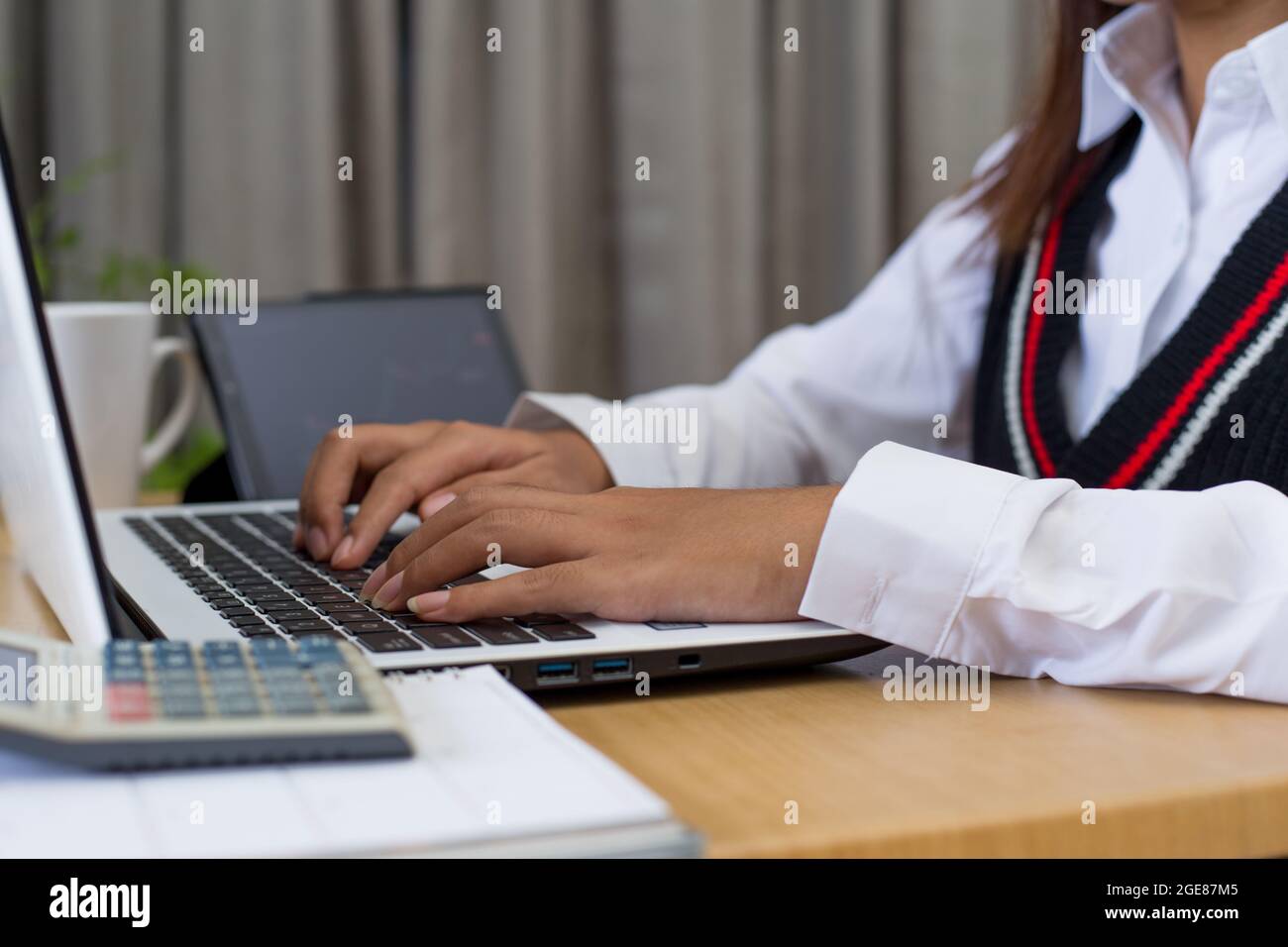 Schoolgirl's hands typing on a laptop Stock Photo - Alamy