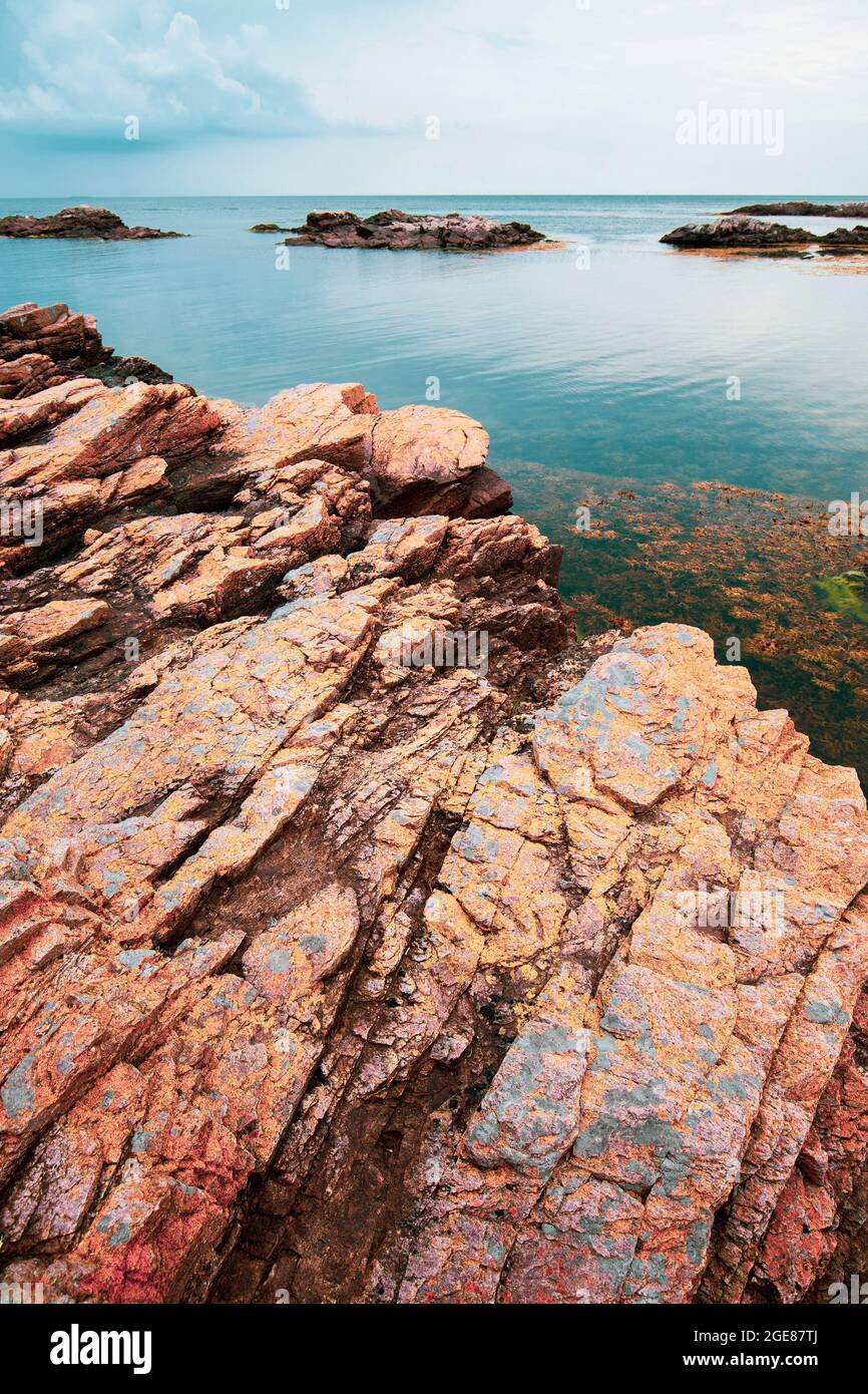 Colorful rock formation around picturesque small town Gudhjem in ...
