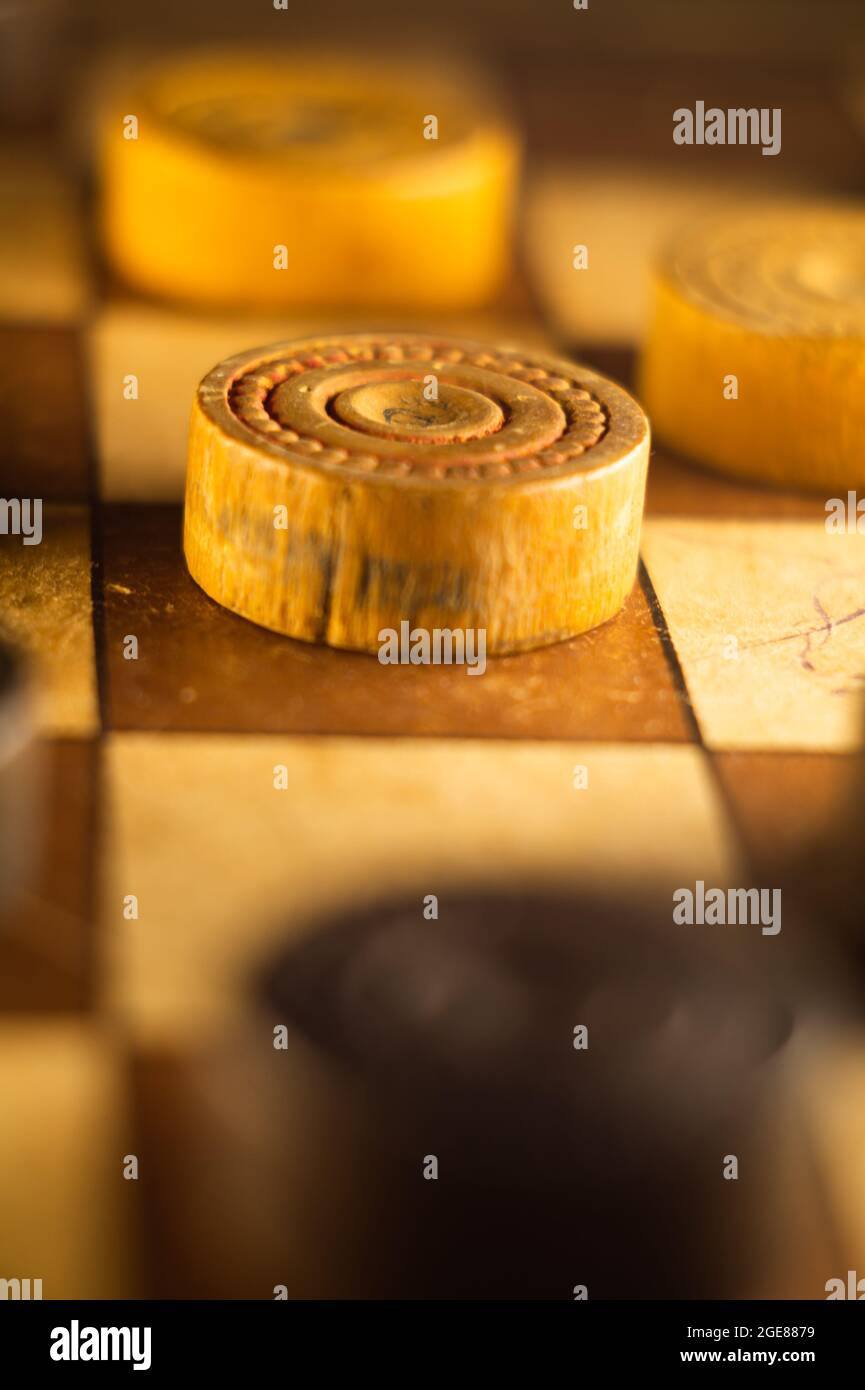 Vertical shot of a checkers board with black and white pieces Stock ...