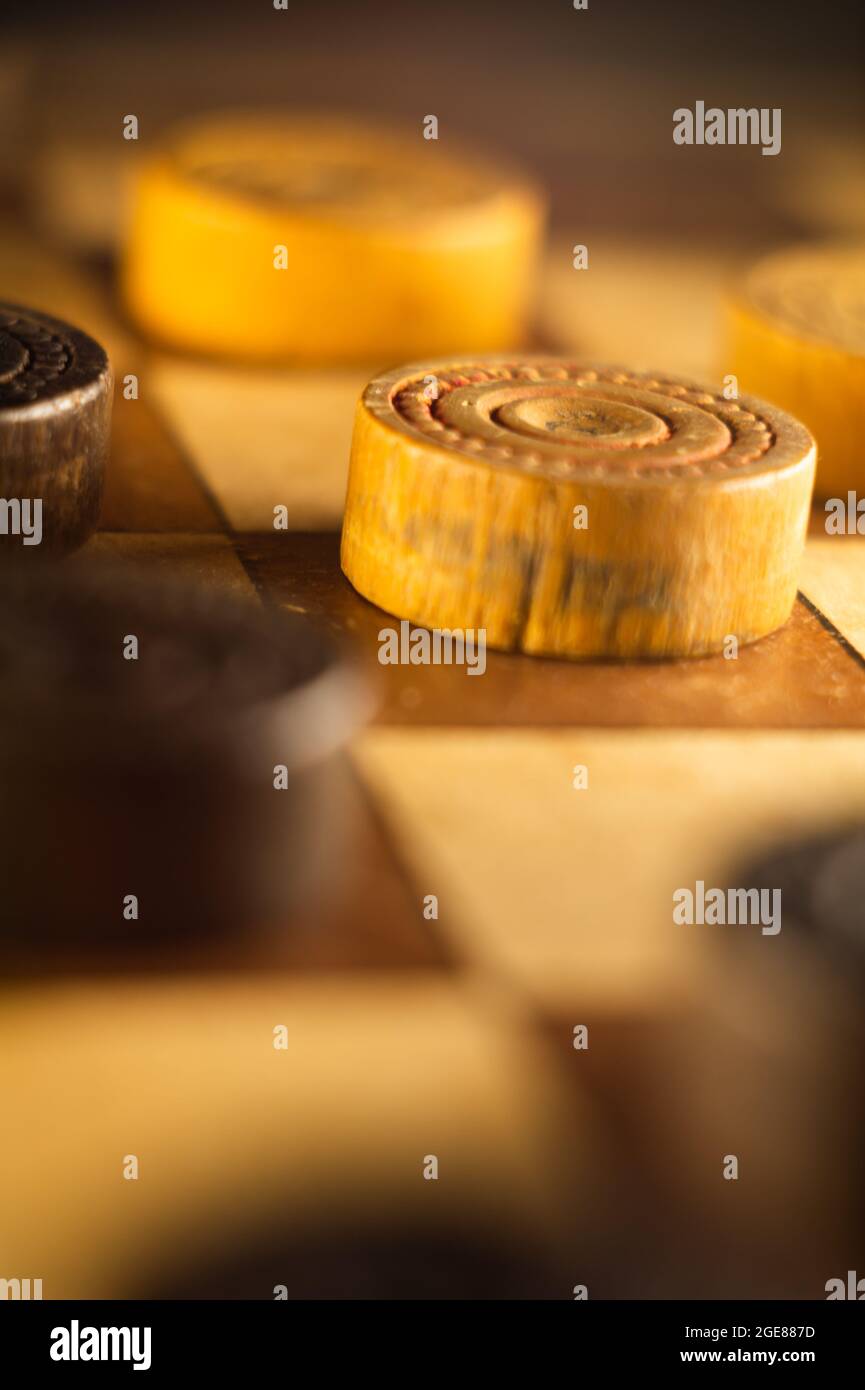 Vertical shot of a checkers board with black and white pieces Stock ...