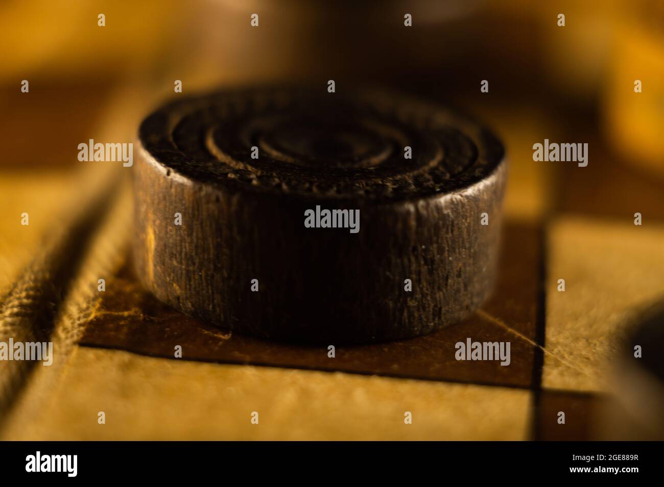 High angle selective focus shot of a checkers board with a black piece ...