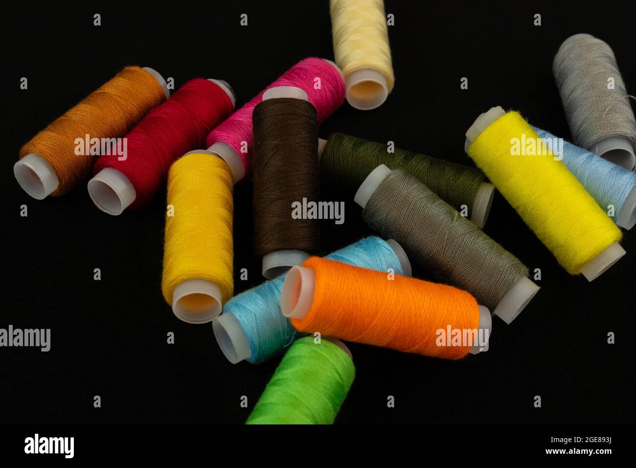 Sewing threads isolated on a black background Stock Photo - Alamy