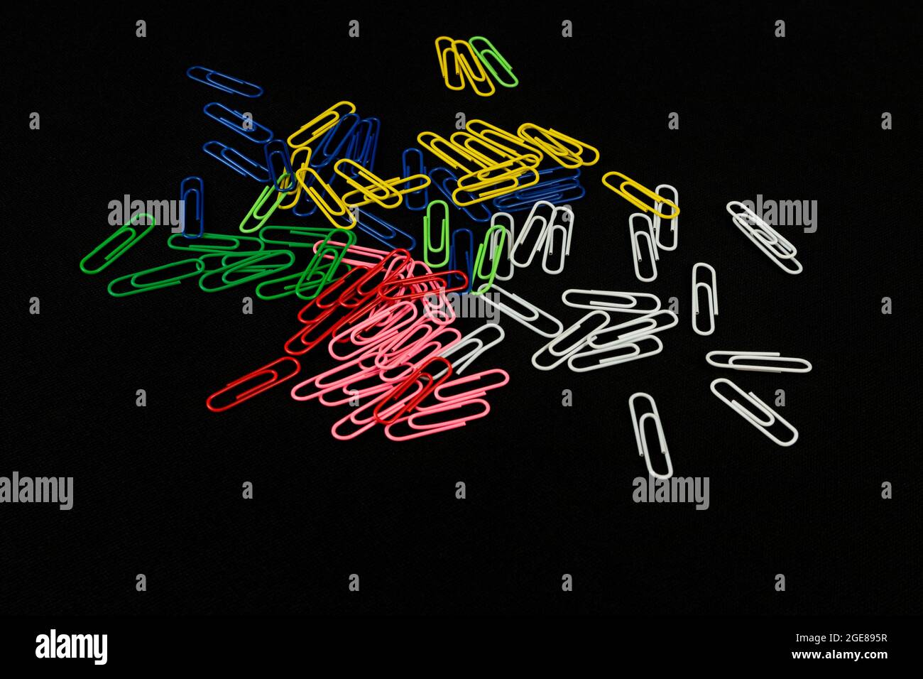 Colorful pile of paper clips on a black background Stock Photo - Alamy