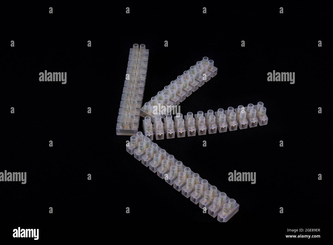 Transparent terminal blocks on a black background Stock Photo - Alamy