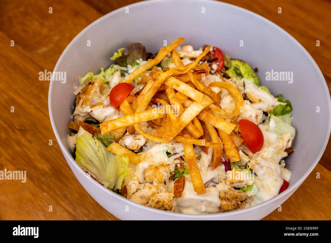 Closeup shot of a Cesar salad in a bowl on a table in a restaurant ...
