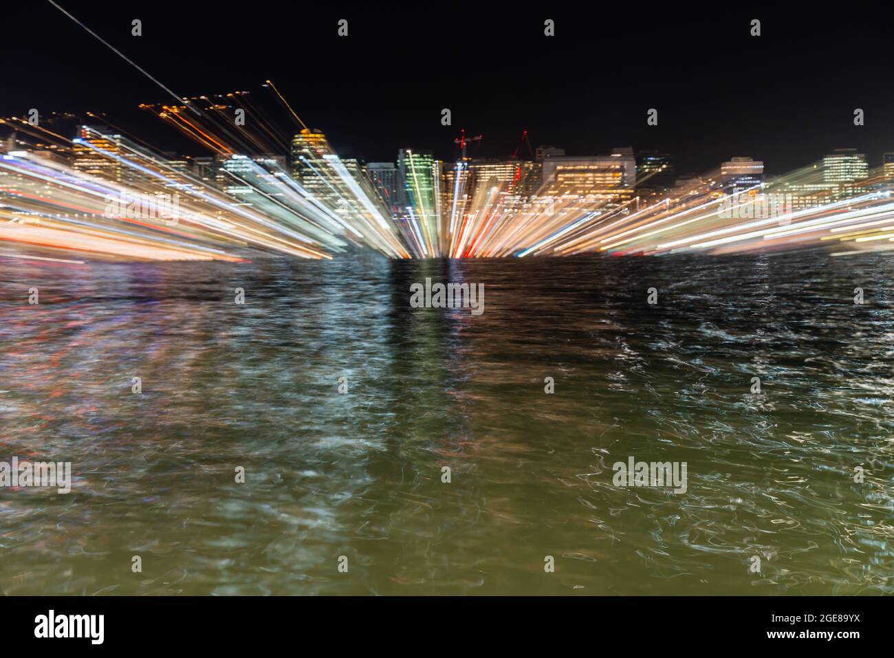 Abstract Wellington urban night lights across harbor in zoom blur ...