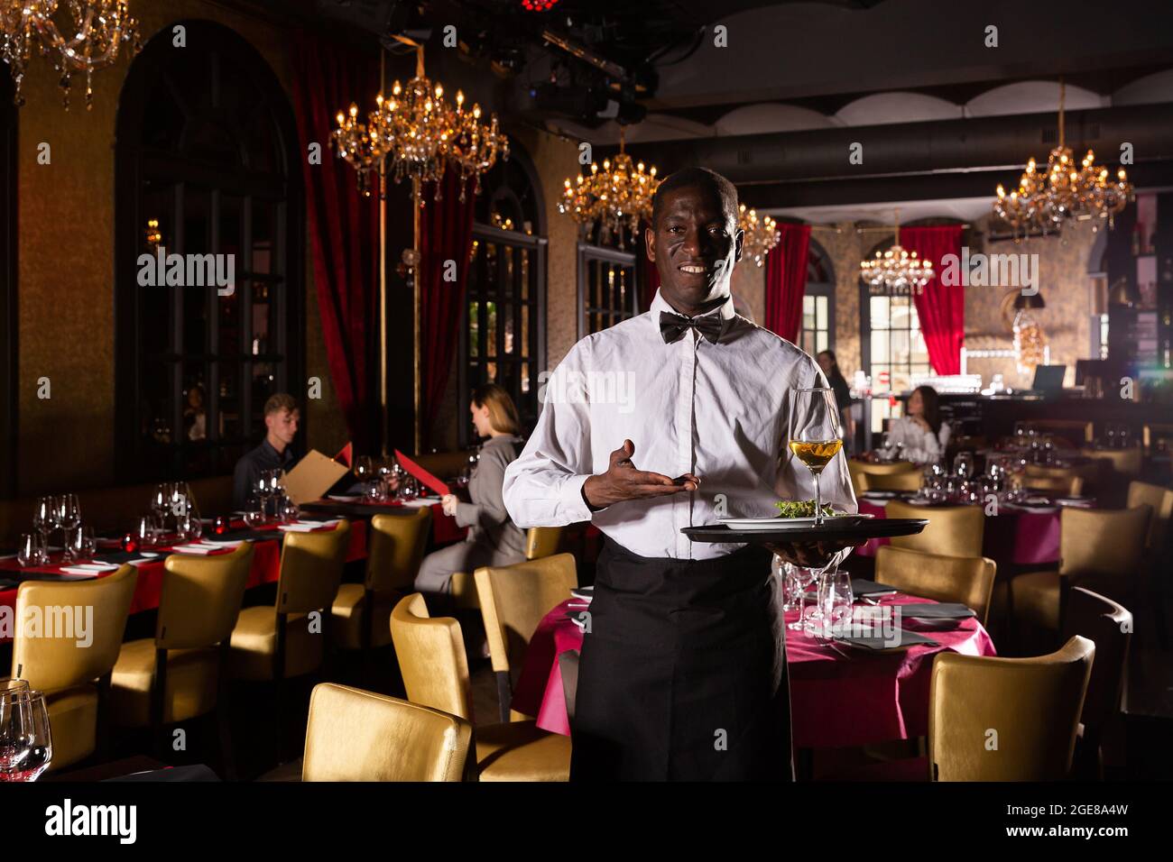 Waiter demonstrating tray of dish Stock Photo - Alamy