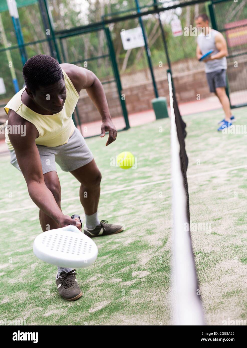 Sporty emotional man playing paddle tennis outdoors Stock Photo - Alamy