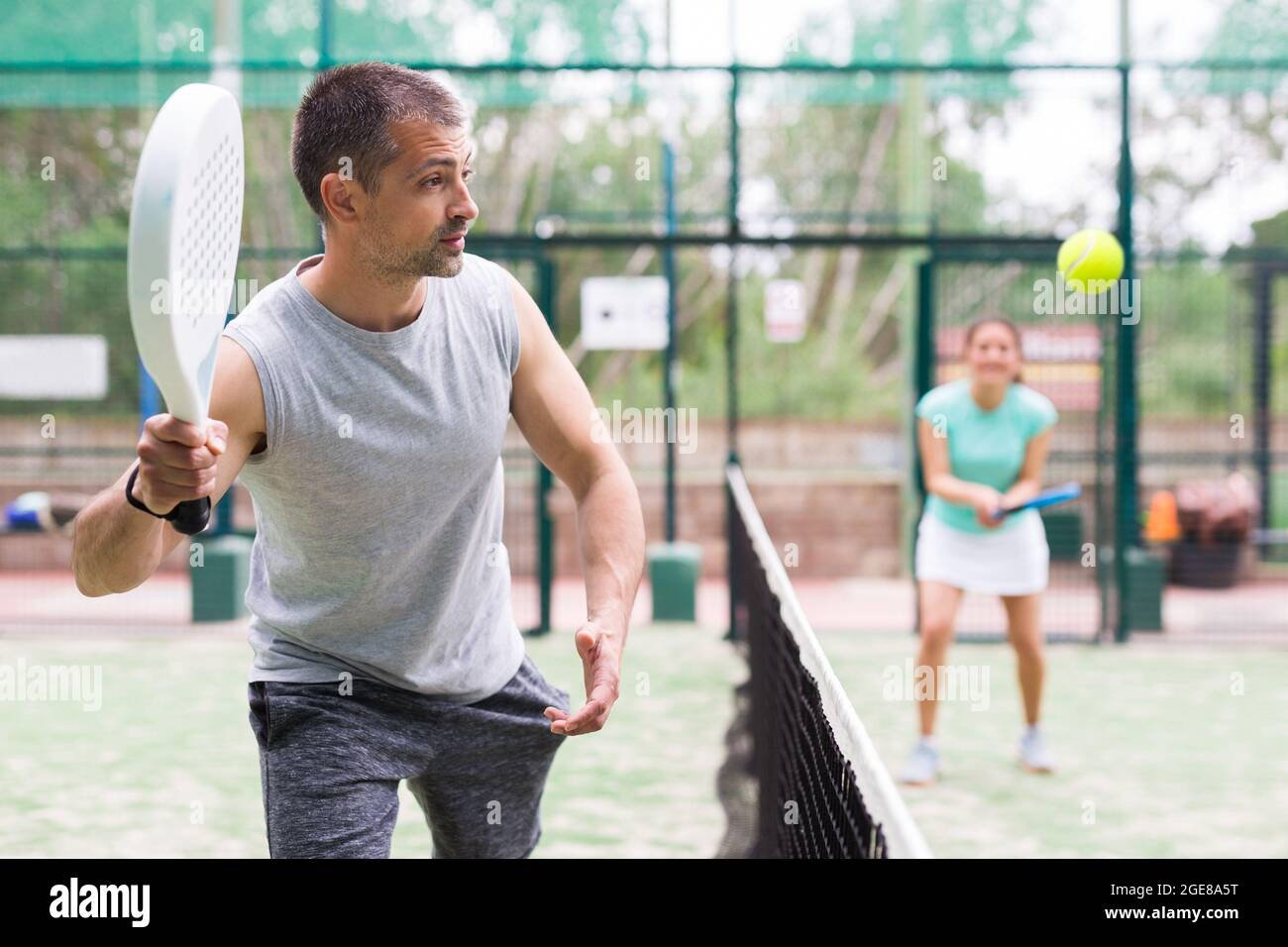 Doubles play in an outdoor paddle game court Stock Photo - Alamy
