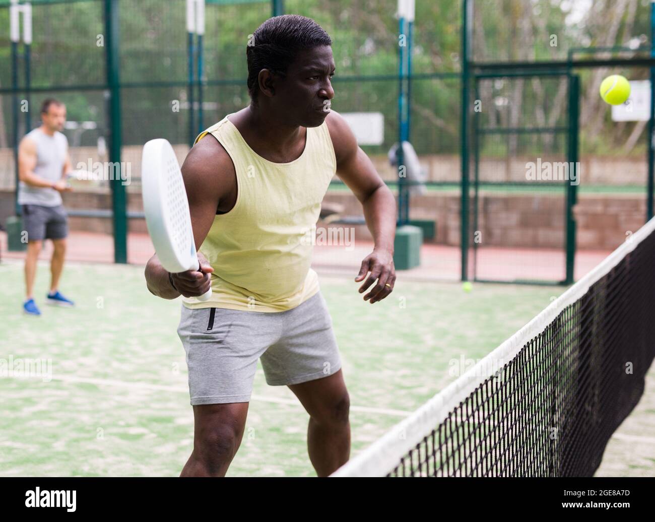 Two padel tennis players play in court Stock Photo - Alamy