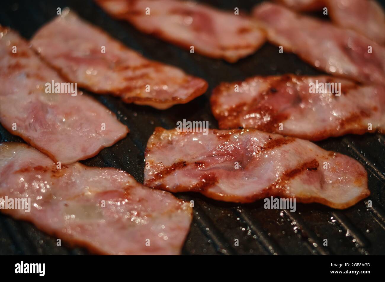 Close up of grilled bacon on the frying pan Stock Photo - Alamy