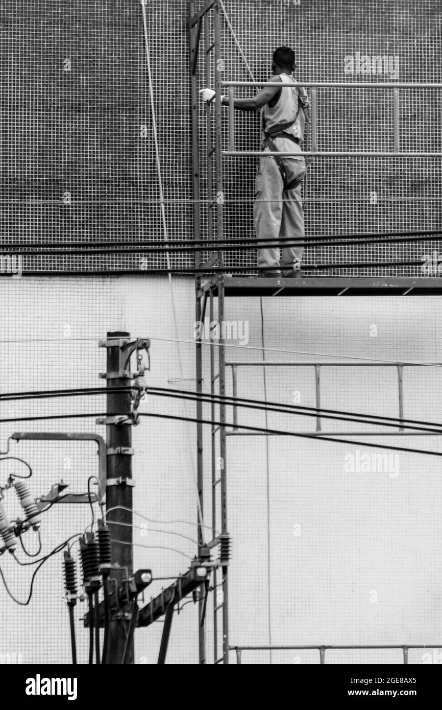 Construction worker with a power line Black and White Stock Photos ...