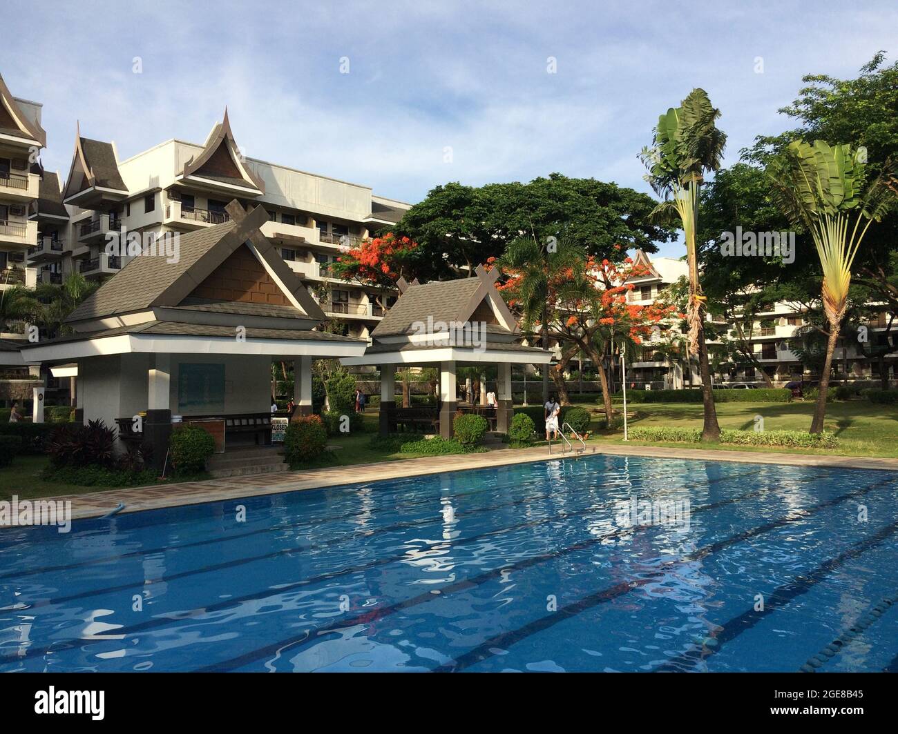 MANILA, PHILIPPINES - Jun 06, 2021: A swimming pool with palm trees ...