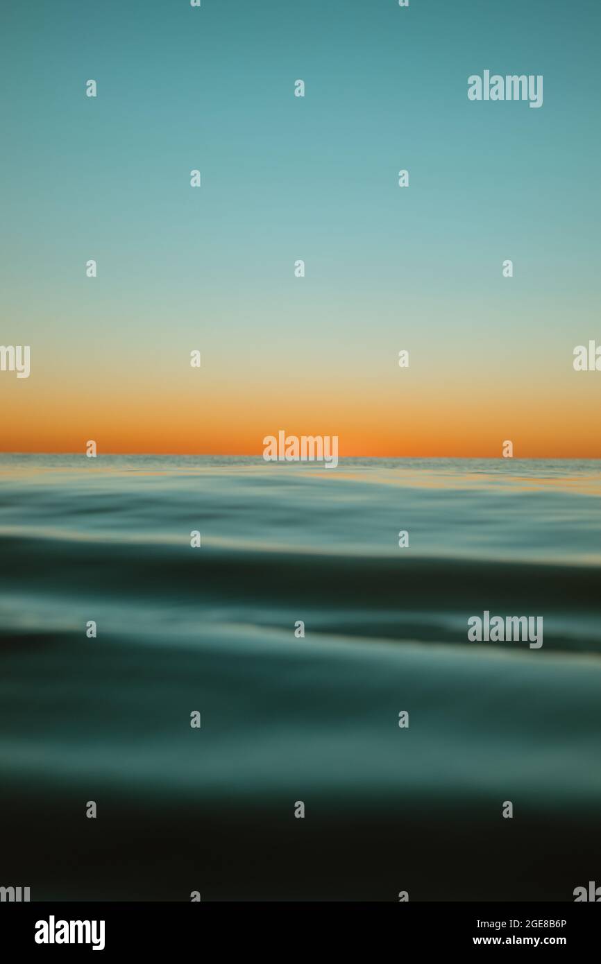 Sun rising over the water at Mollymook Beach Stock Photo - Alamy