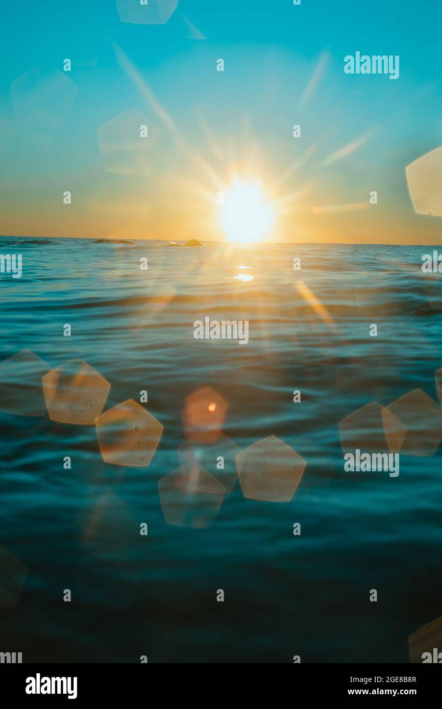 Sun rising over the water at Mollymook Beach Stock Photo - Alamy