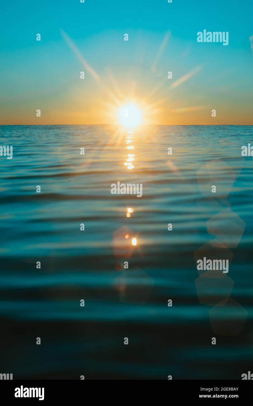 Sun rising over the water at Mollymook Beach Stock Photo - Alamy