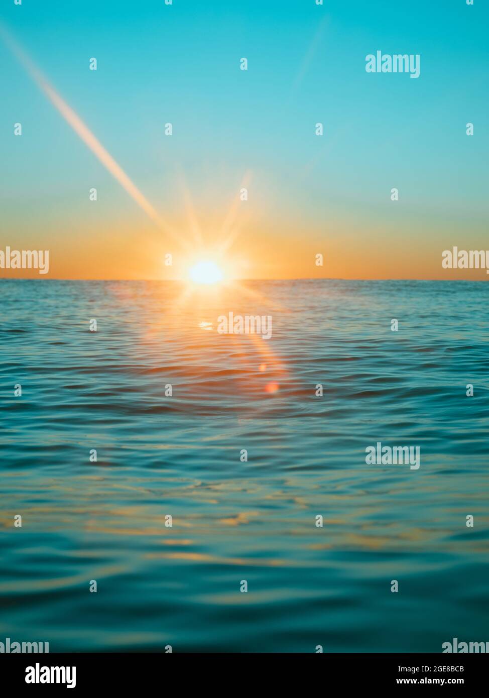 Sun rising over the water at Mollymook Beach Stock Photo - Alamy