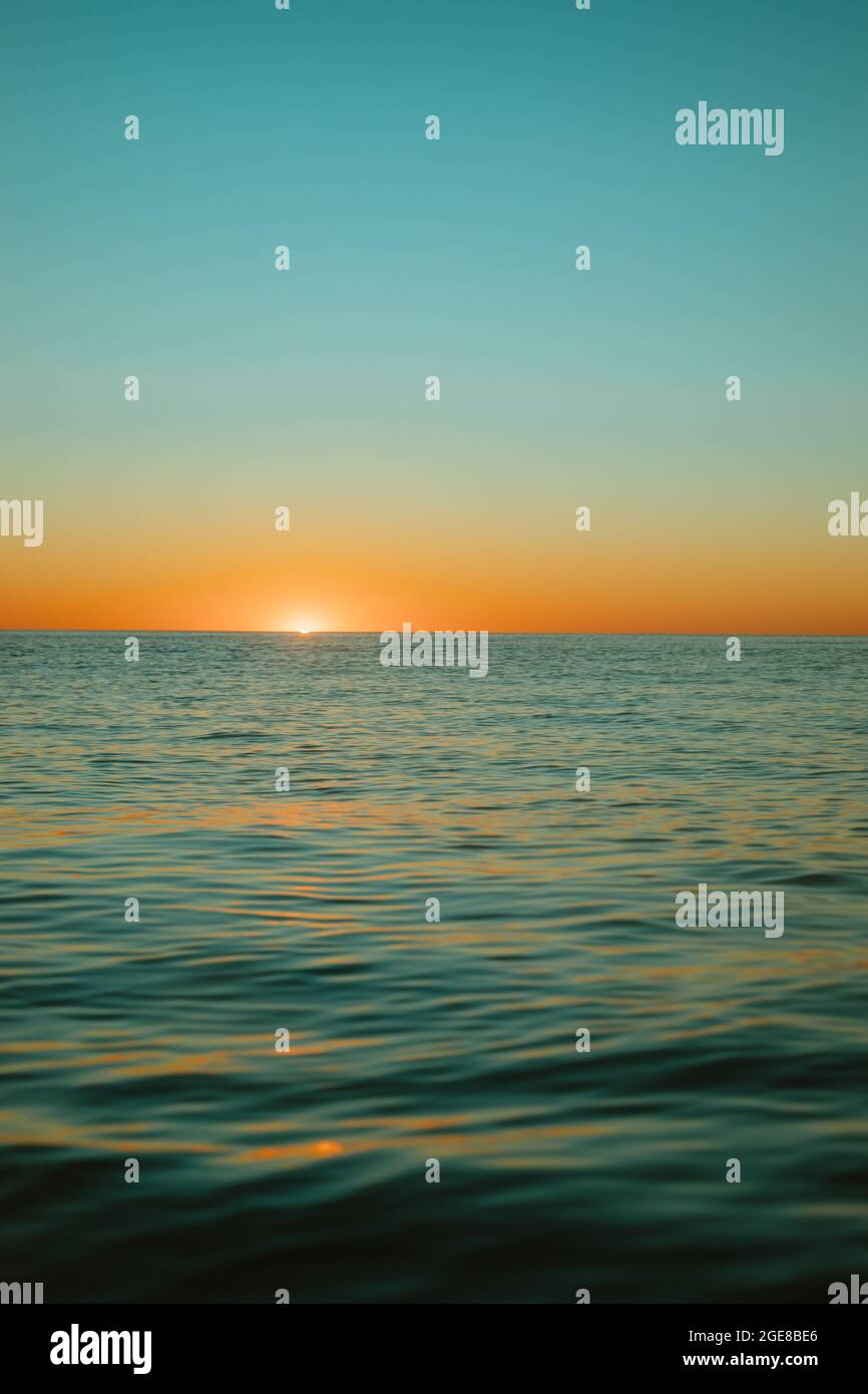 Sun rising over the water at Mollymook Beach Stock Photo - Alamy