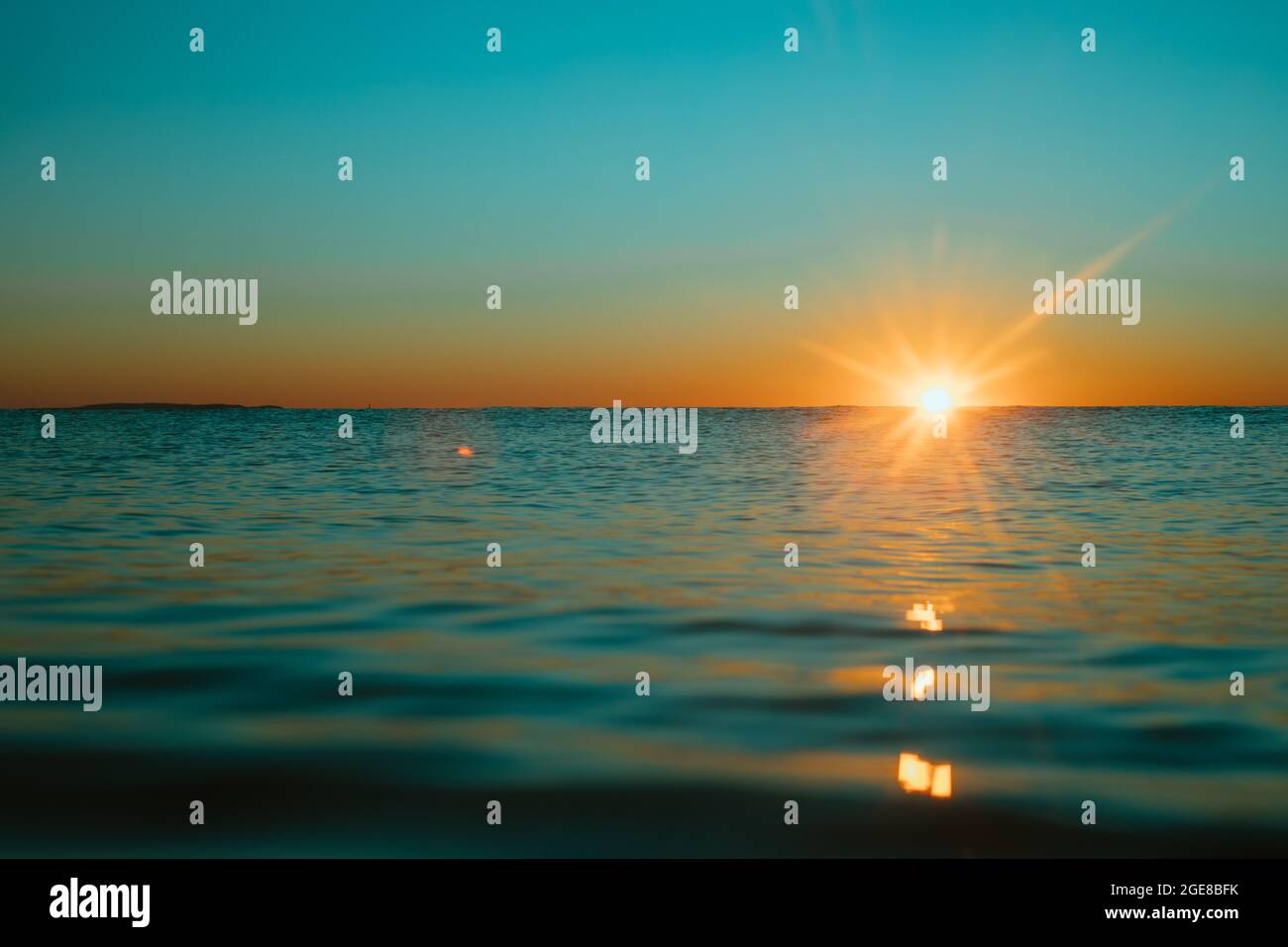 Sun rising over the water at Mollymook Beach Stock Photo - Alamy