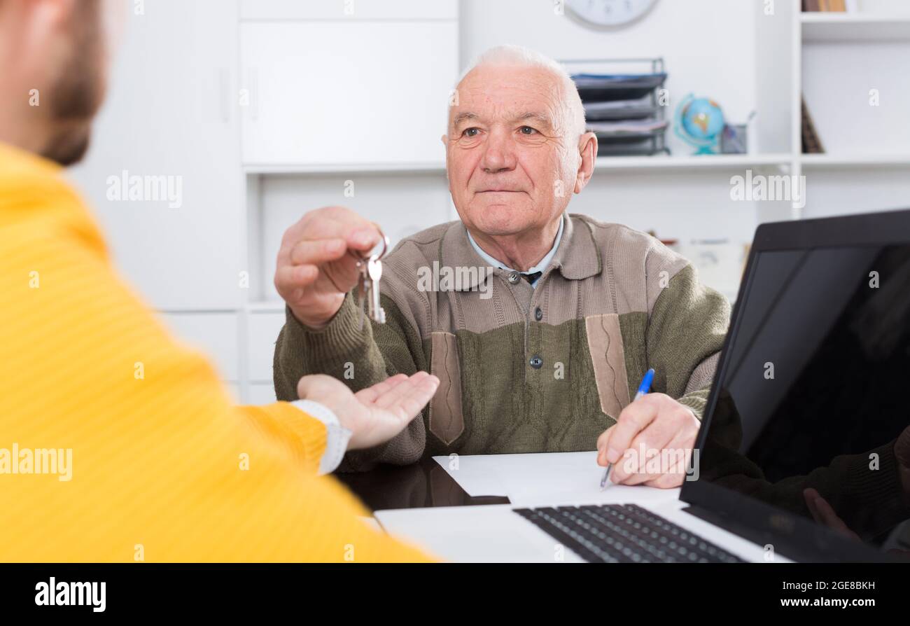 Man selling house in office Stock Photo - Alamy