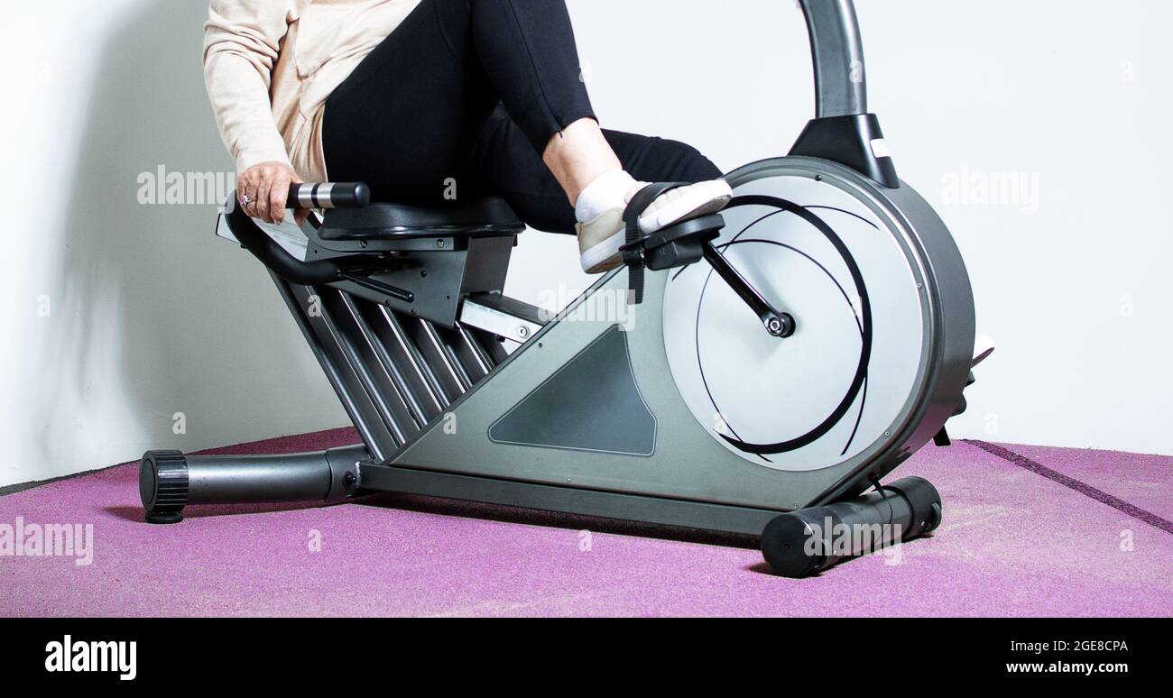 Female legs on an elliptical trainer in the gym Stock Photo - Alamy