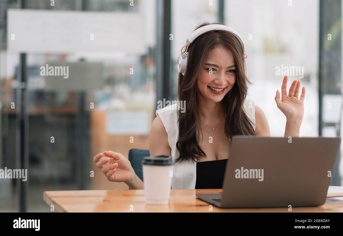 Smiling girl student wear wireless headphone study online with teacher ...