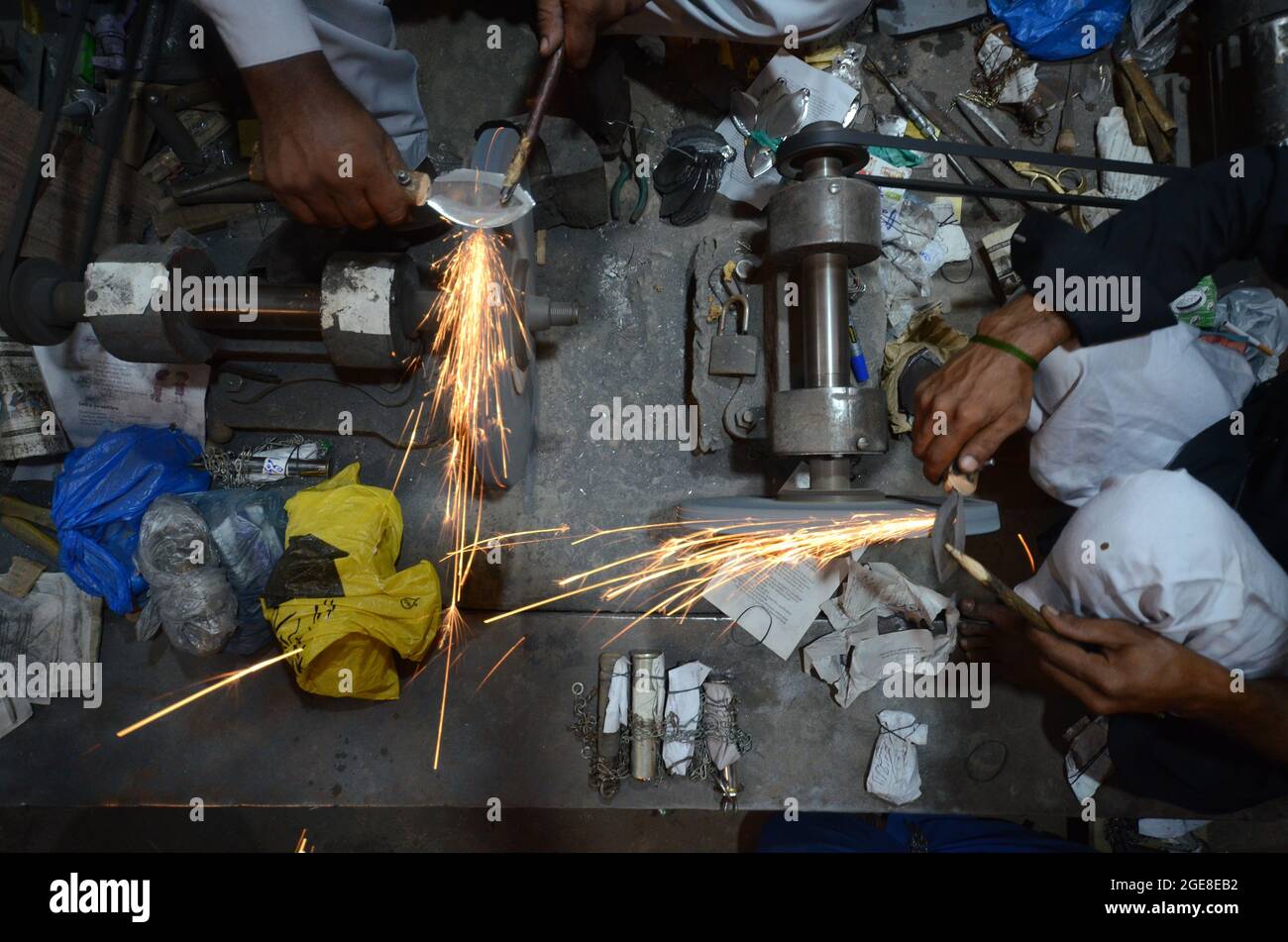 Peshawar, Pakistan. 17th Aug, 2021. Pakistani workers sharpen knives at ...