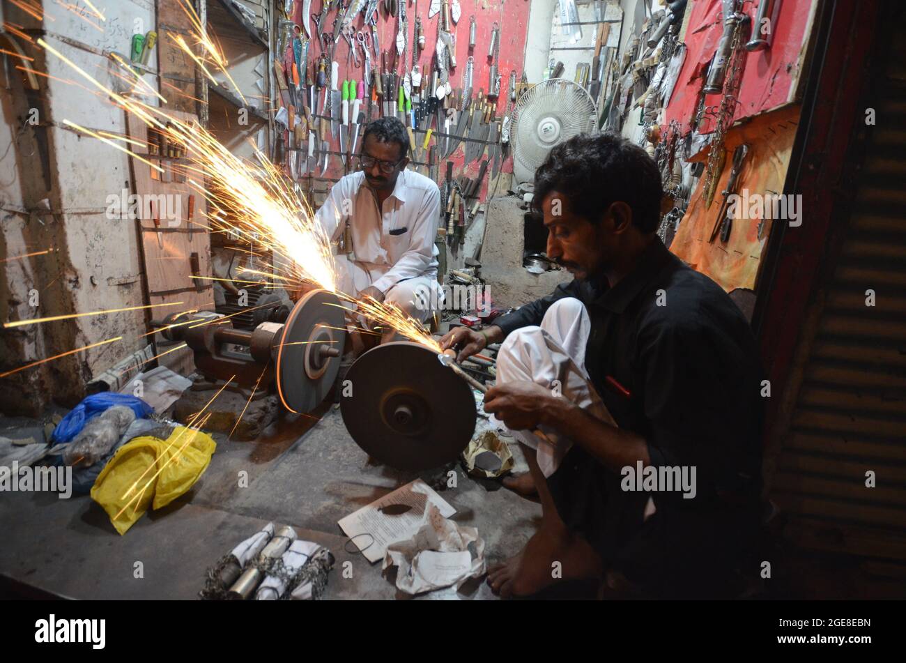 Peshawar, Pakistan. 17th Aug, 2021. Pakistani workers sharpen knives at ...