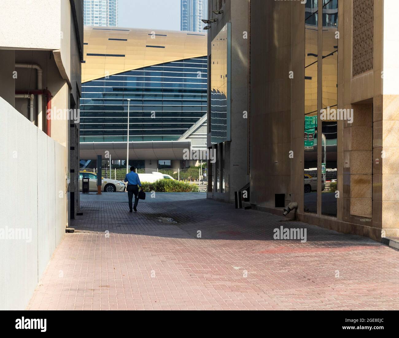 Person passing trough buildings Stock Photo - Alamy
