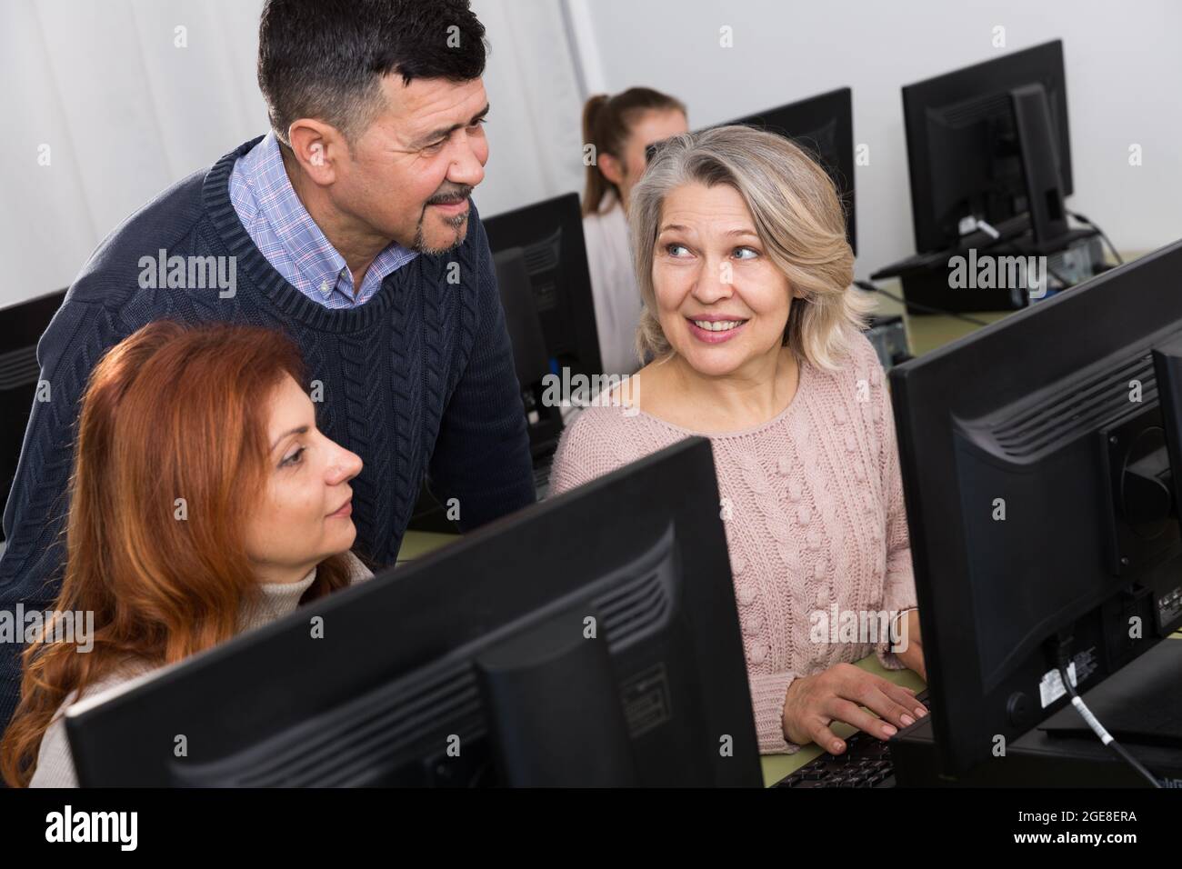 Mature people working together on computer Stock Photo - Alamy