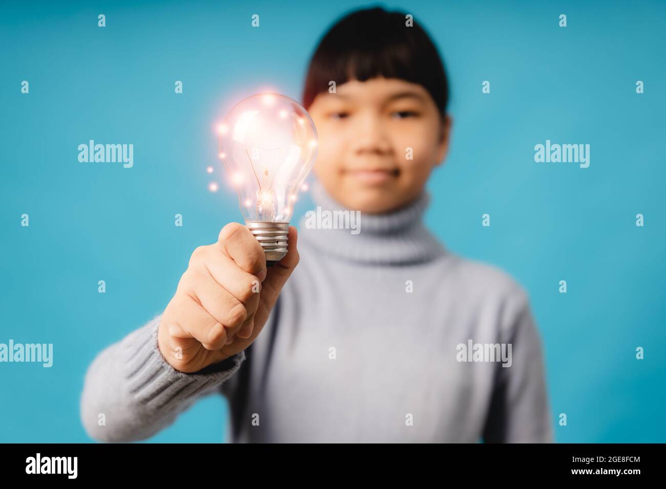 Asian girl kid holding lighting bulb of creative idea and bright ...