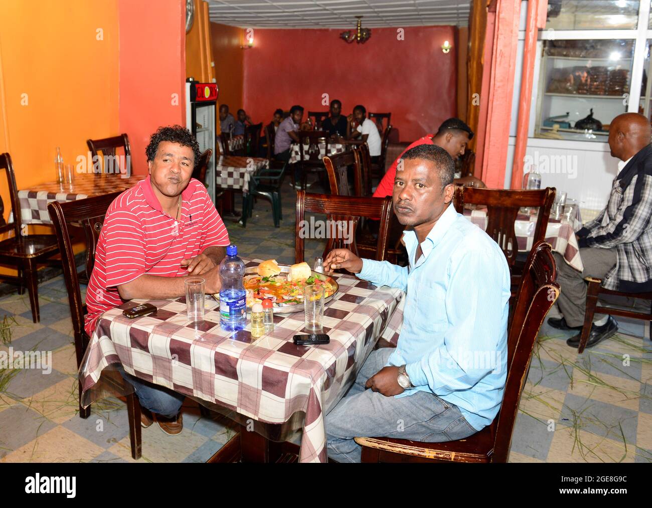 Ethiopian men enjoying eating Injera together at the Elsa Shiro ...