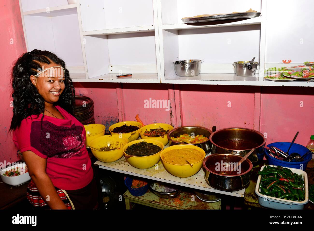A cook with the various vegetables prepared for the injera dish at the ...