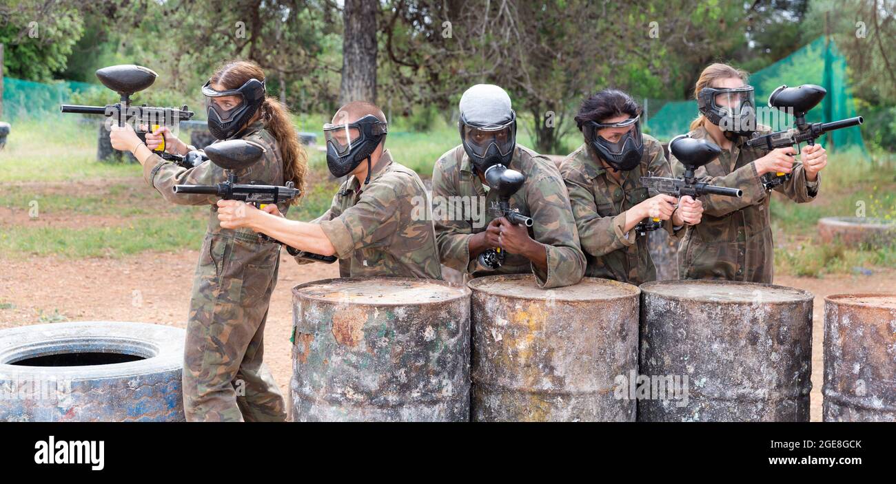 Paintball players of opposite teams in shootout Stock Photo - Alamy