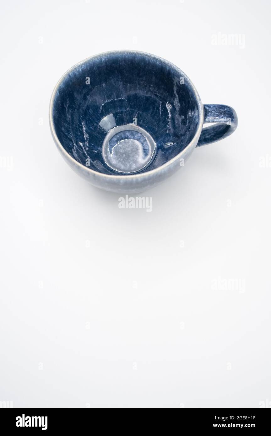 Ceramic blue tea cup isolated on a white background with free space for ...