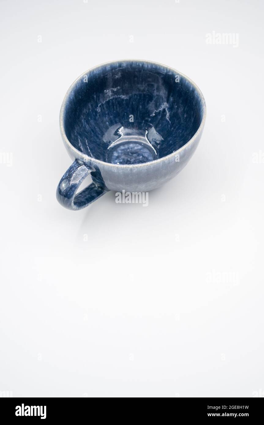 Ceramic blue tea cup isolated on a white background with free space for ...
